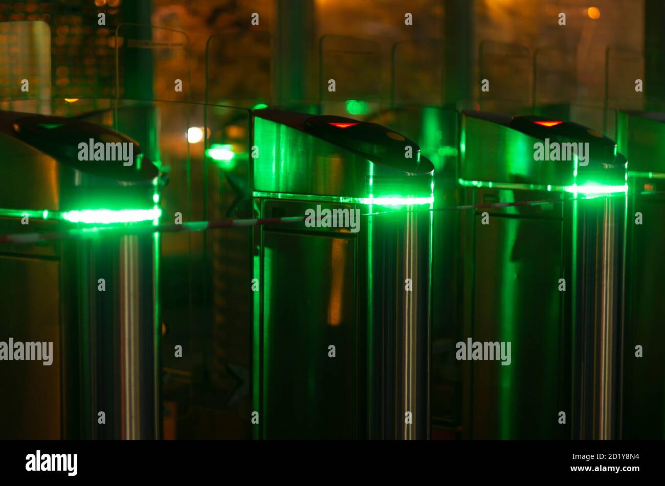 Night scene with three turnstiles with green led lighting without ...
