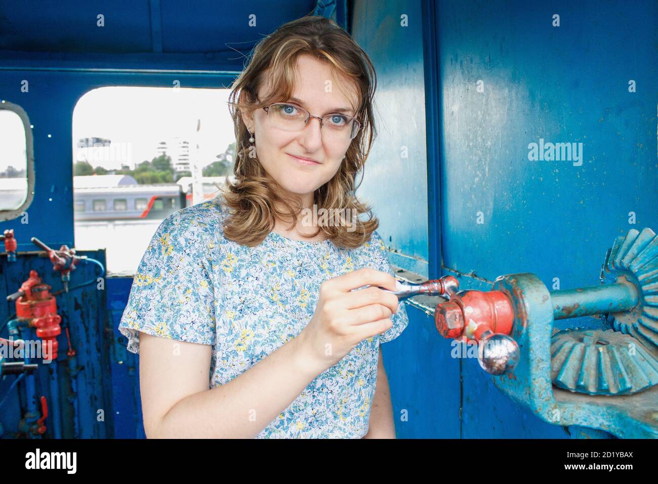 Spinning mechanism in women's hands. The girl in the cabin of a steam ...