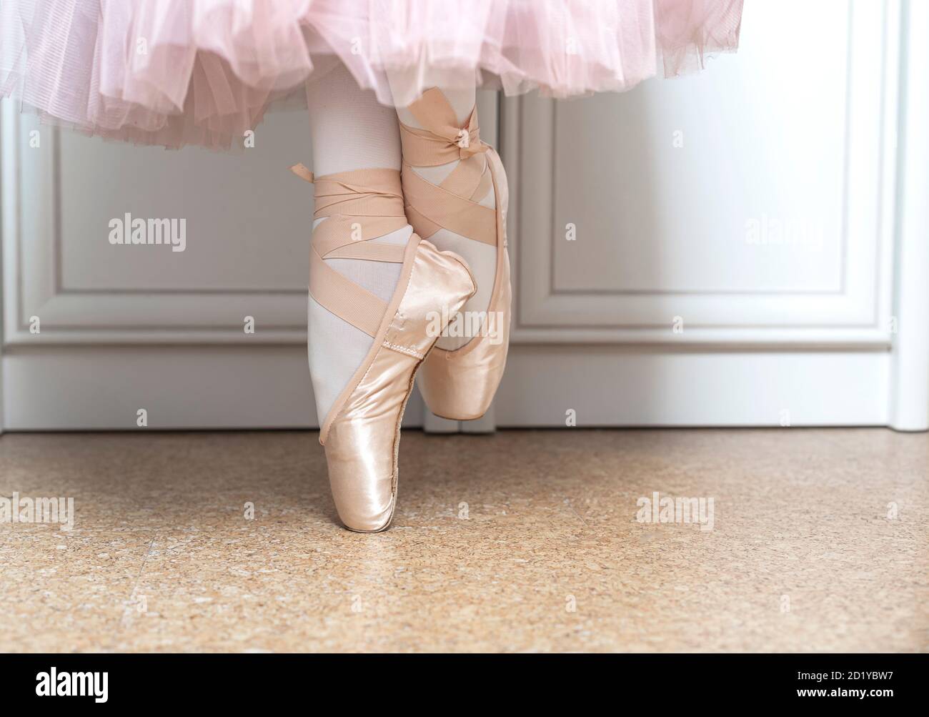 Legs of ballerina in ballet shoes, closeup. Distant training with ...