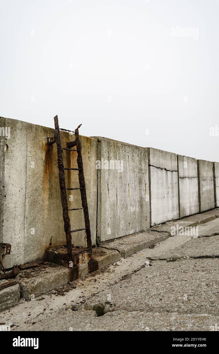 Rusty metal ladder on the stone pier Stock Photo - Alamy