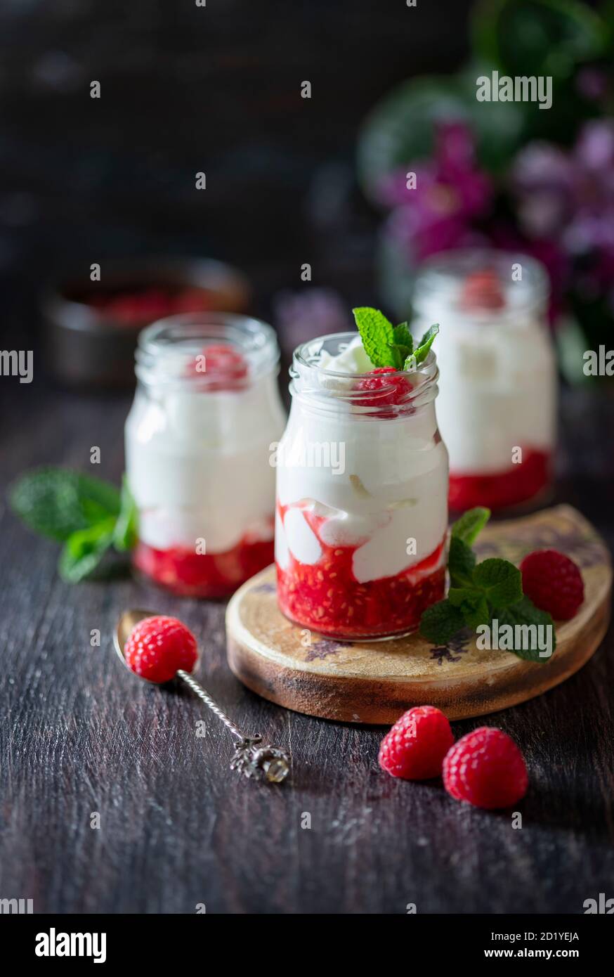 Fermented drink kefir, yogurt in a glass jar on a dark wooden ...