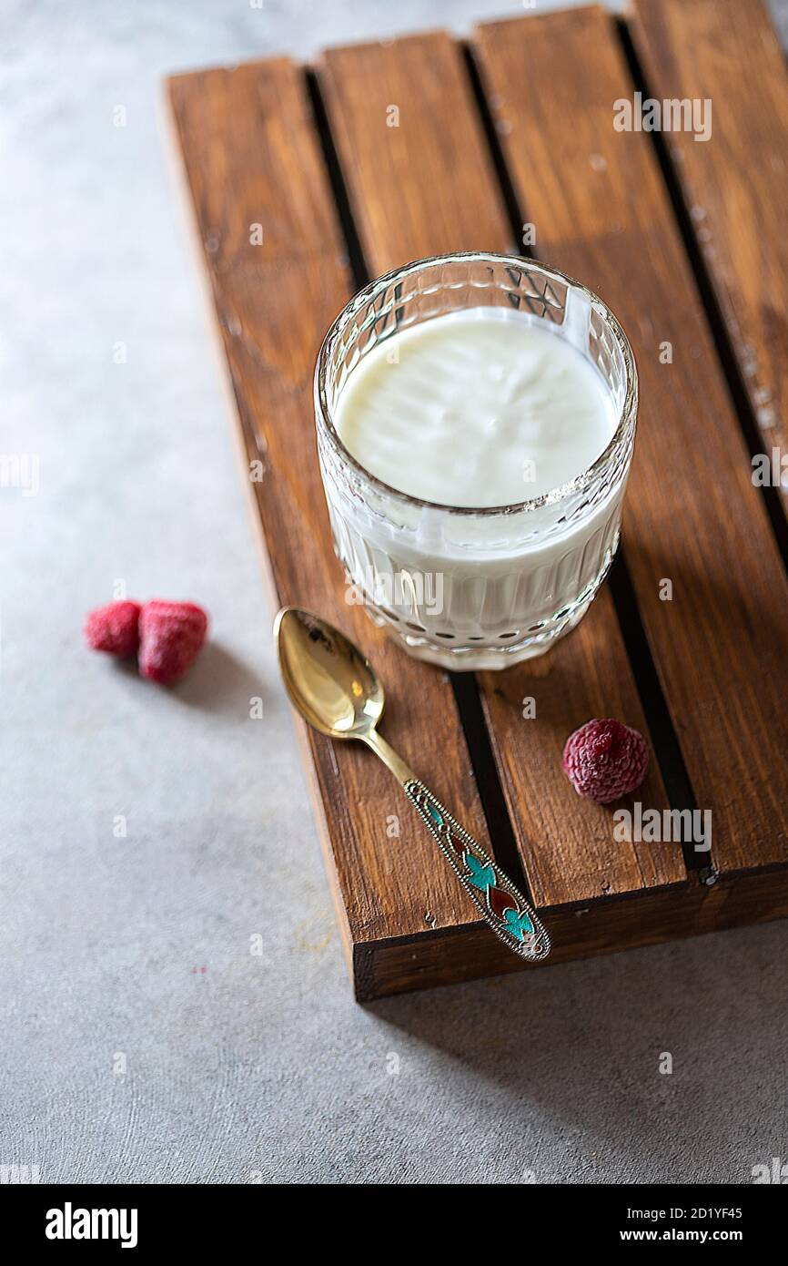 Fermented drink kefir in a glass jar on a light background. Probiotic ...