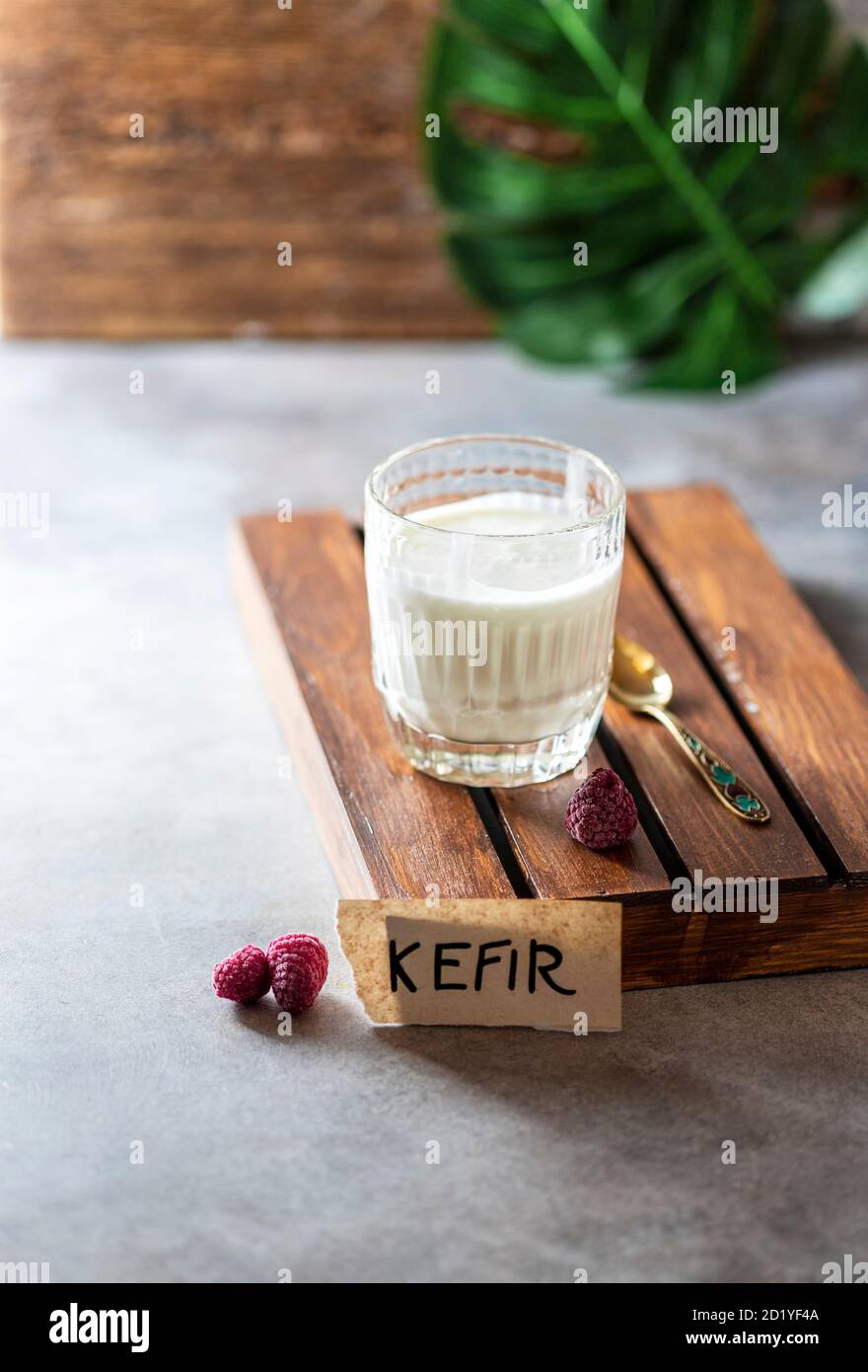 Fermented drink kefir in a glass jar on a light background. Probiotic ...