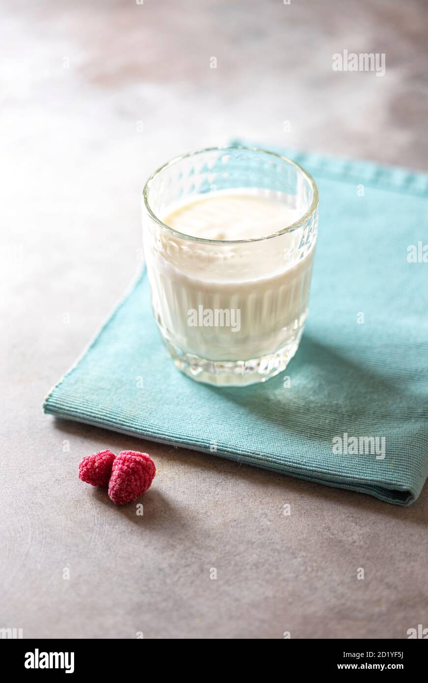 Fermented drink kefir in a glass jar on a light background. Probiotic ...