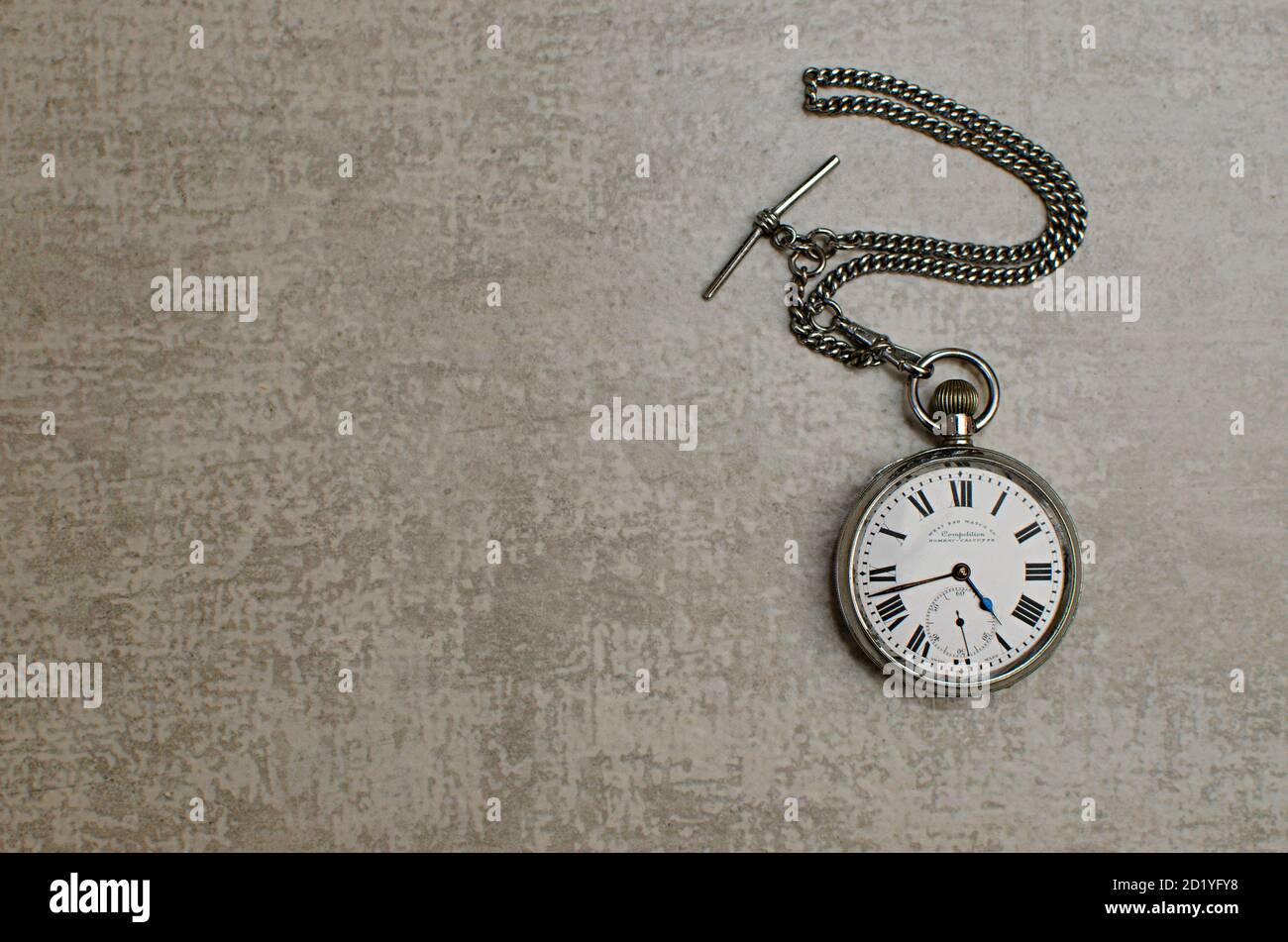 Old fashioned pocket watch with chain. Roman numbers indicating time ...