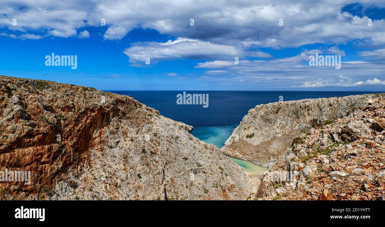 Rocky red cliffs of typical Greek view, azure sea, clear blue sky ...