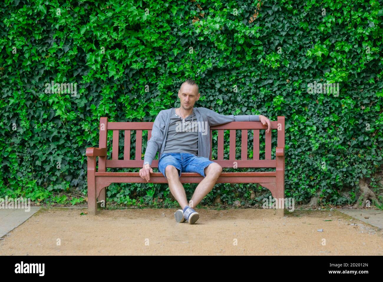 Lonely man sitting alone on bench and dreaming. Loneliness concept ...