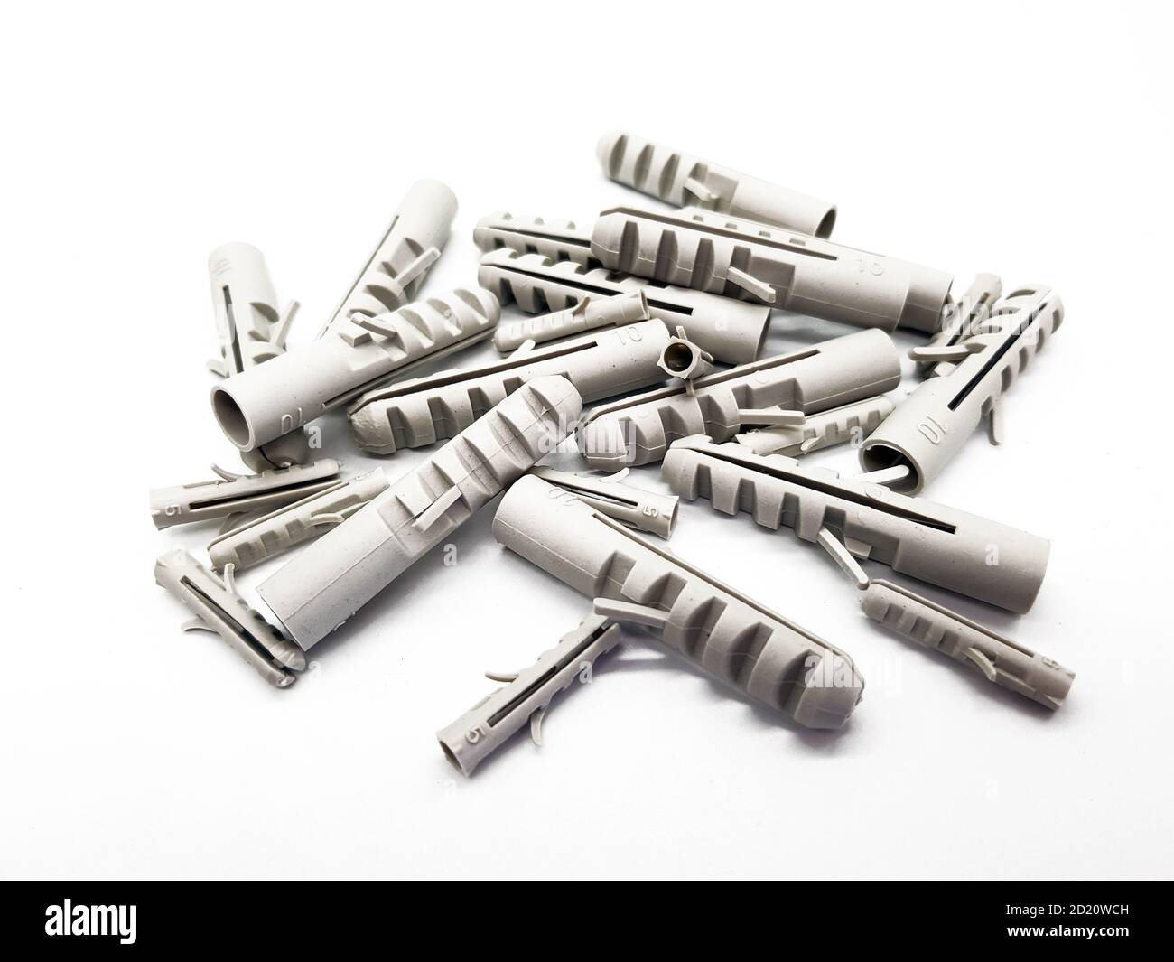 Closeup of a pile of wall dowel plugs isolated on a white background ...