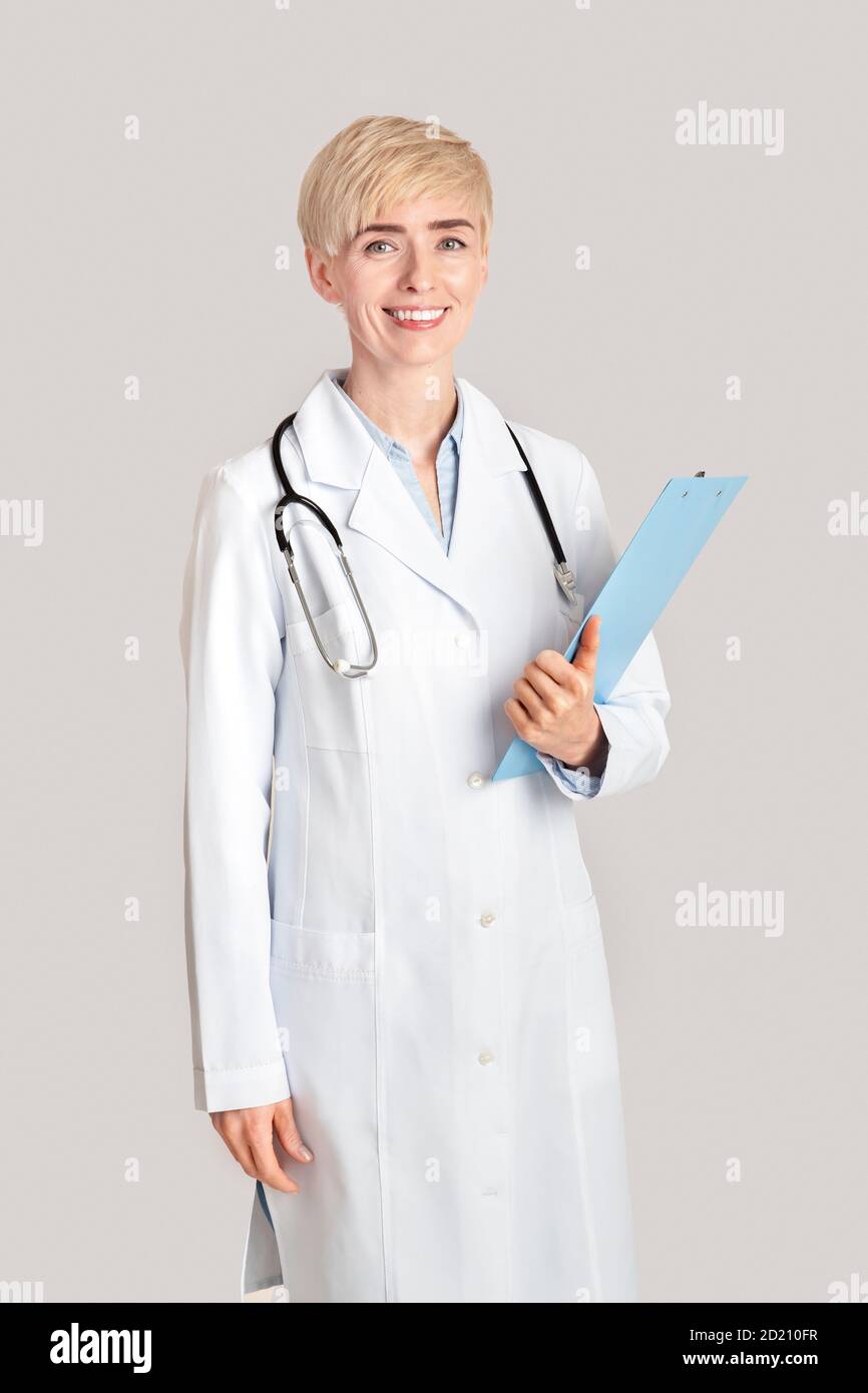 Examination, health care and hospital. Friendly female doctor holding ...