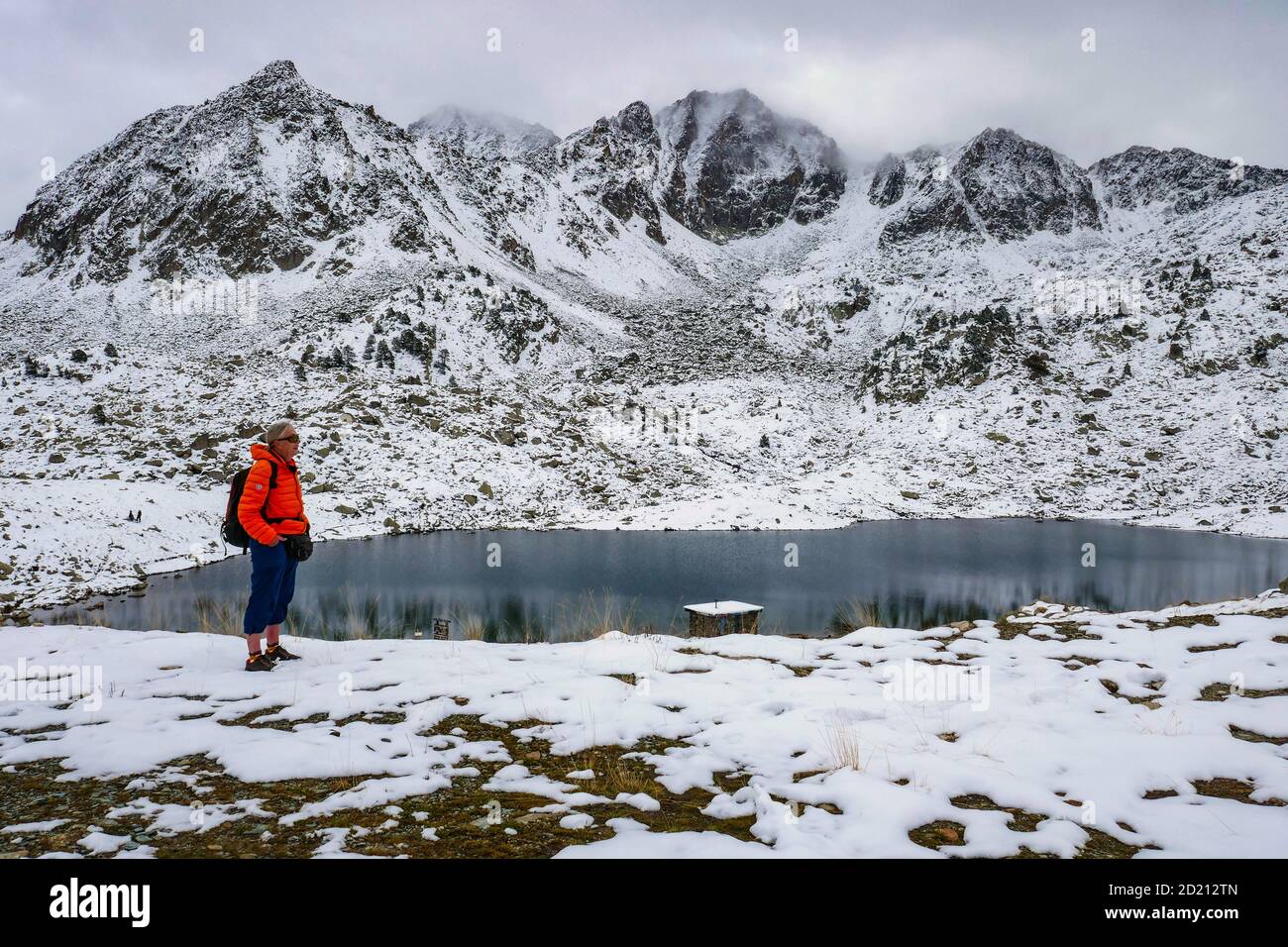 Solitary female walker, hiker, at the Estany de Font Negra with early ...