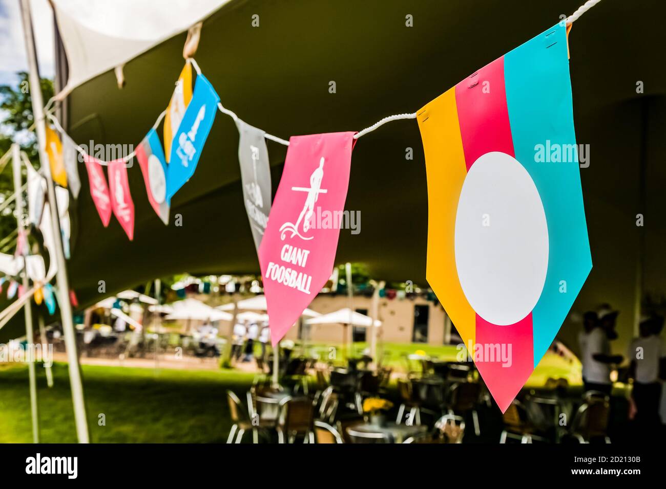 Paper bunting strings attached to tents for outdoor party or corporate ...