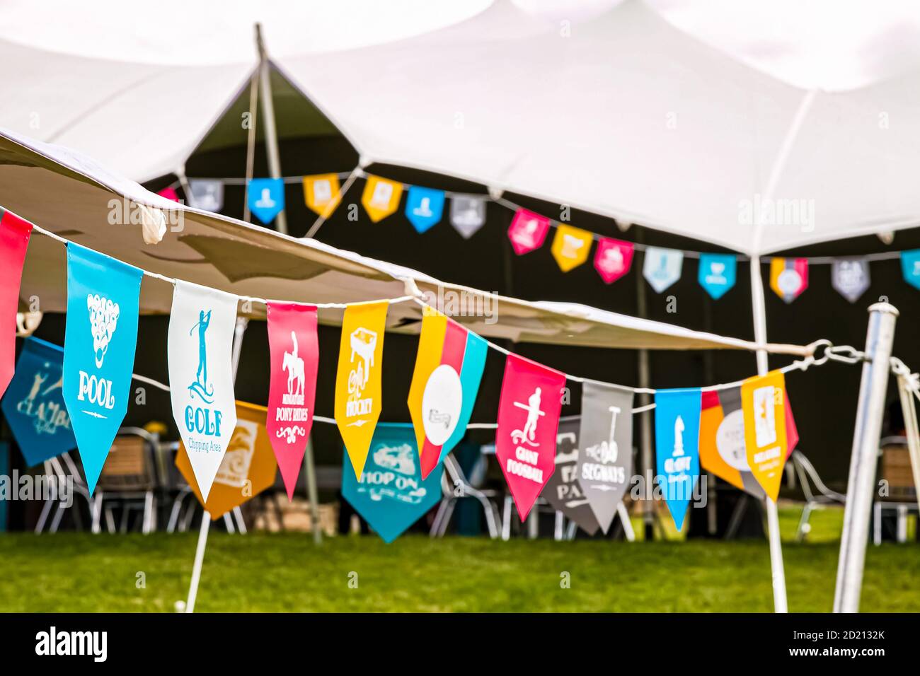 Paper bunting strings attached to tents for outdoor party or corporate ...