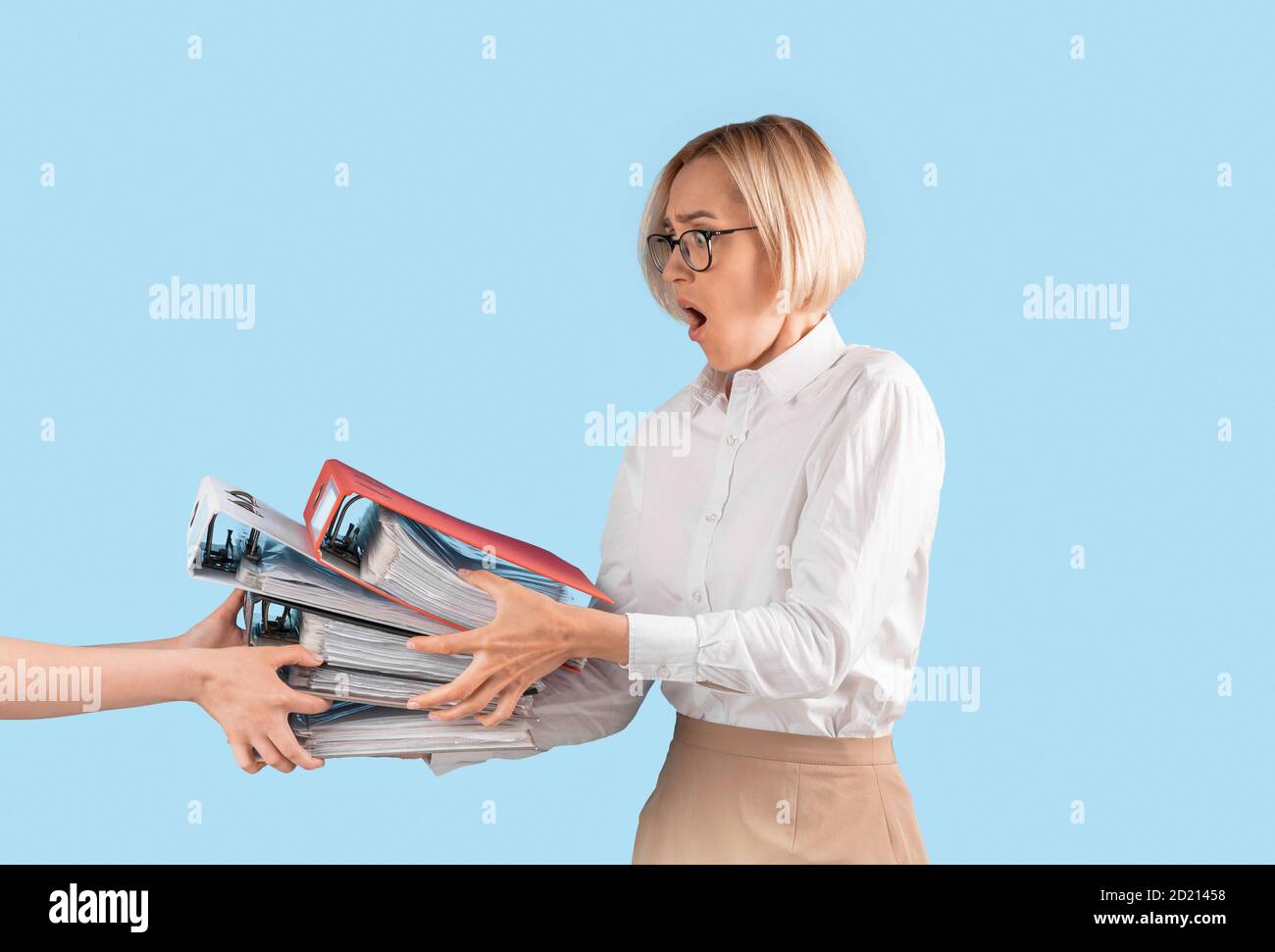 Frustrated office worker taking folders of documents from boss on blue ...