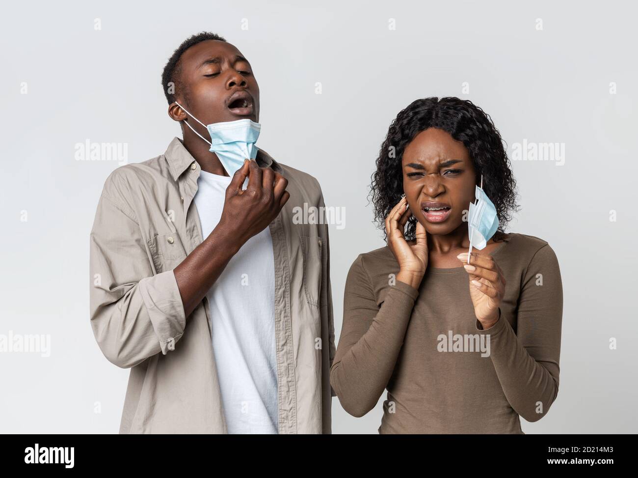 Black couple removing face masks for sneezing Stock Photo - Alamy