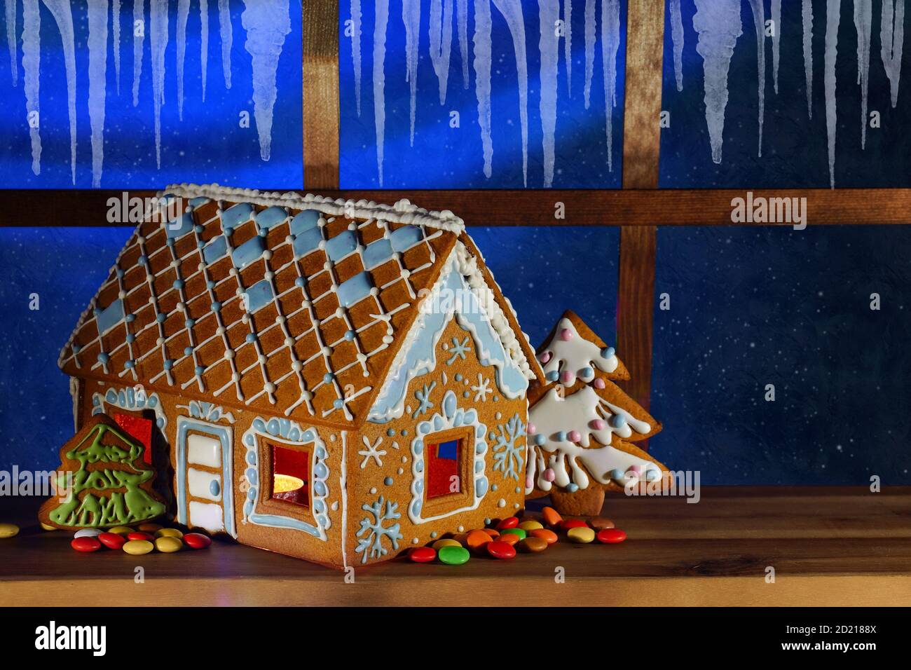 Gingerbread house on the background of the night window. Christmas ...