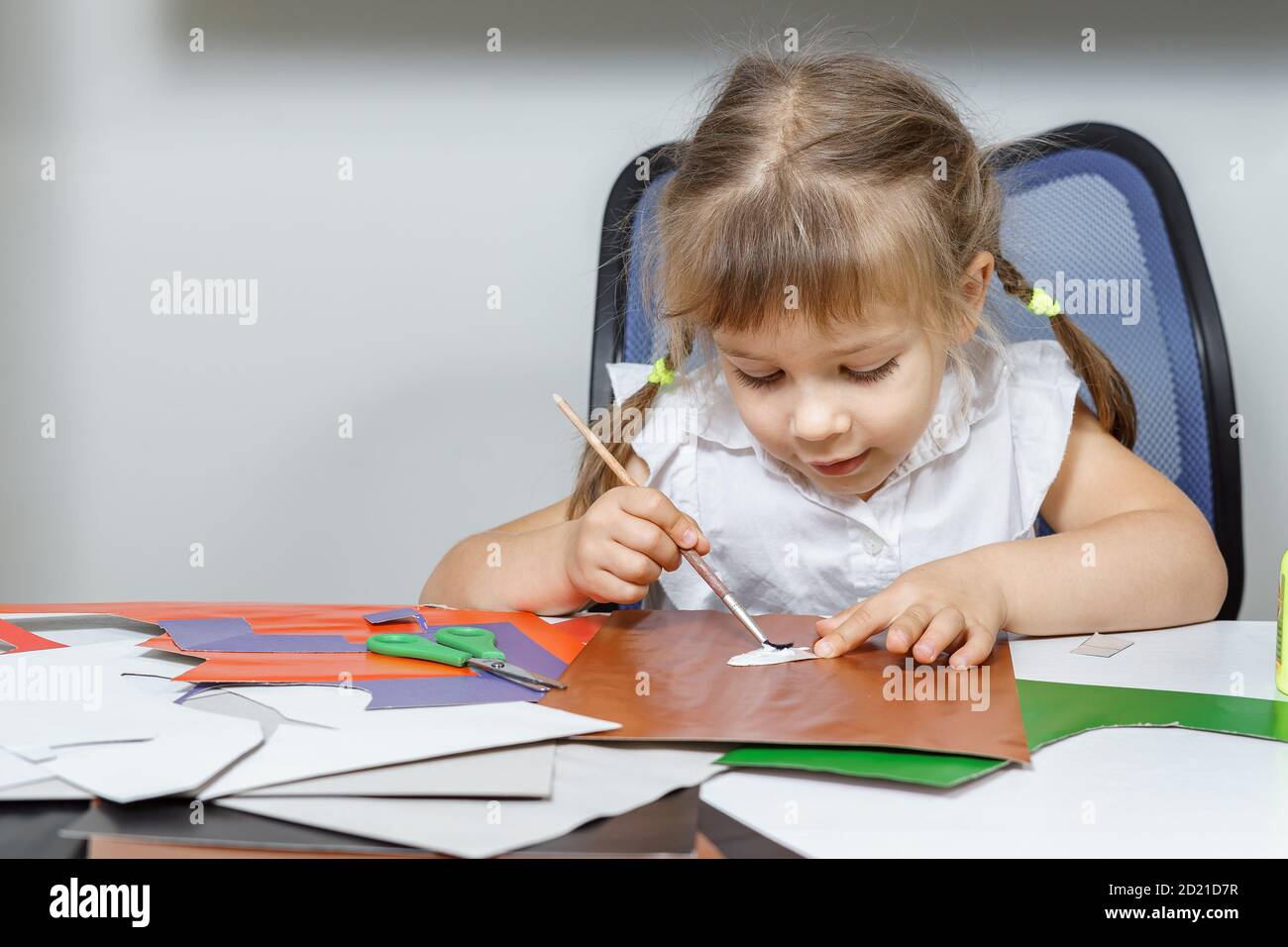 Child using glue hi-res stock photography and images - Alamy