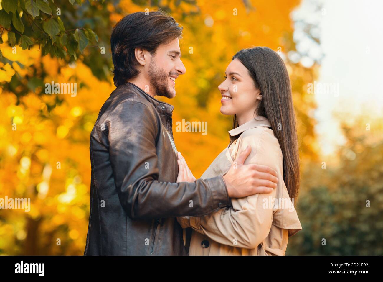 Positive couple embracing and joking, having date at park Stock Photo ...