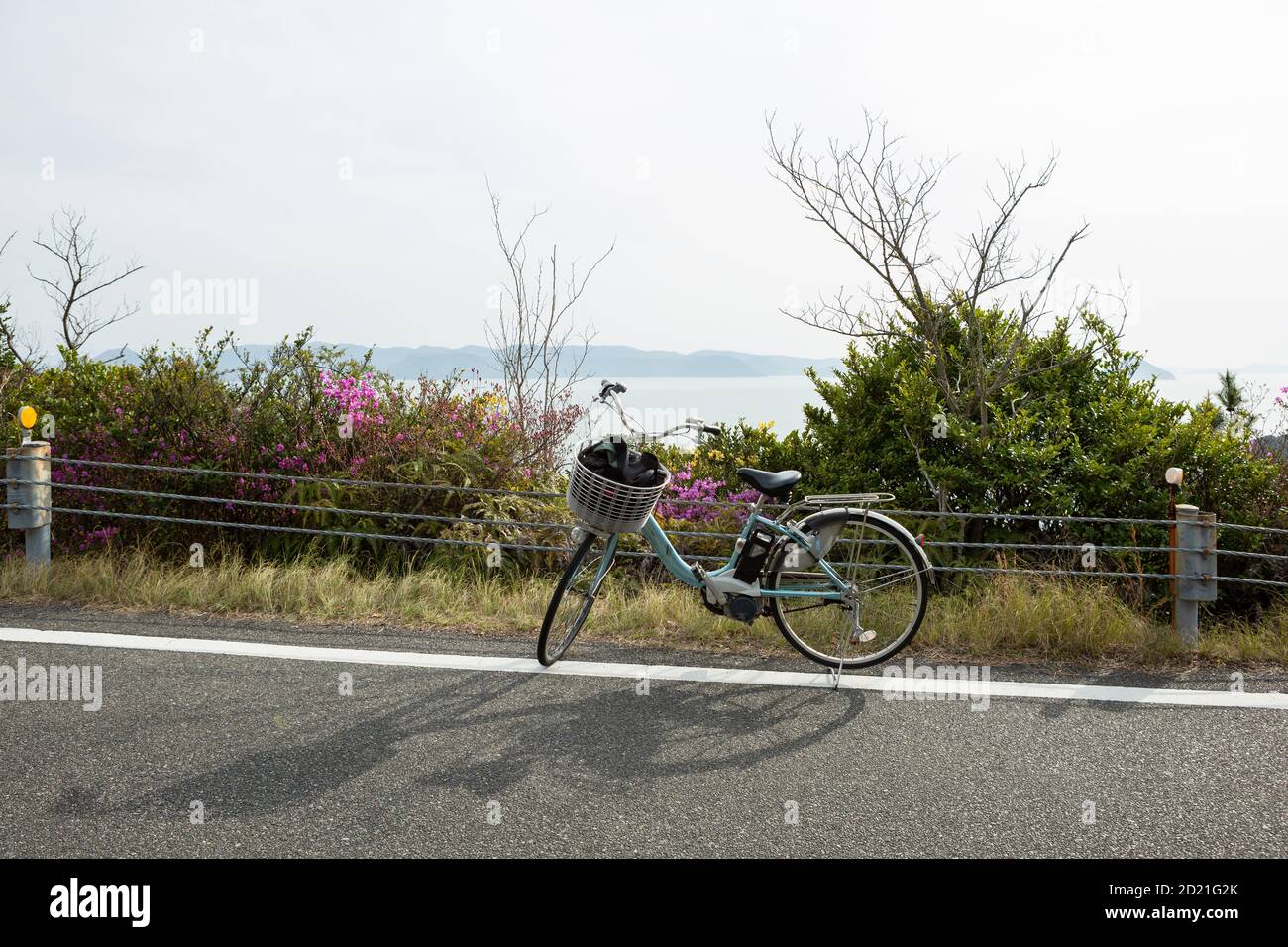 Electric bike by the side of the road, Naoshima, Japan Stock Photo - Alamy