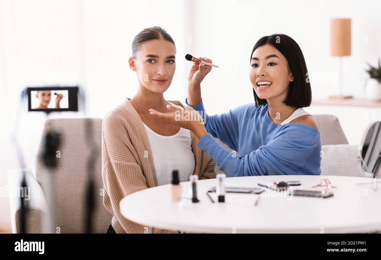 Asian Woman Doing Makeup For Her Model Stock Photo - Alamy