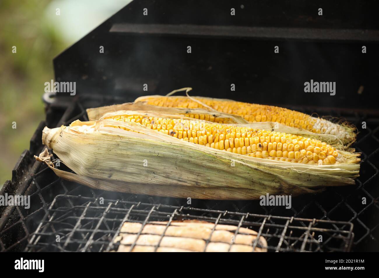 Yellow corn cooked on a grill. Preparing healthy food Stock Photo - Alamy