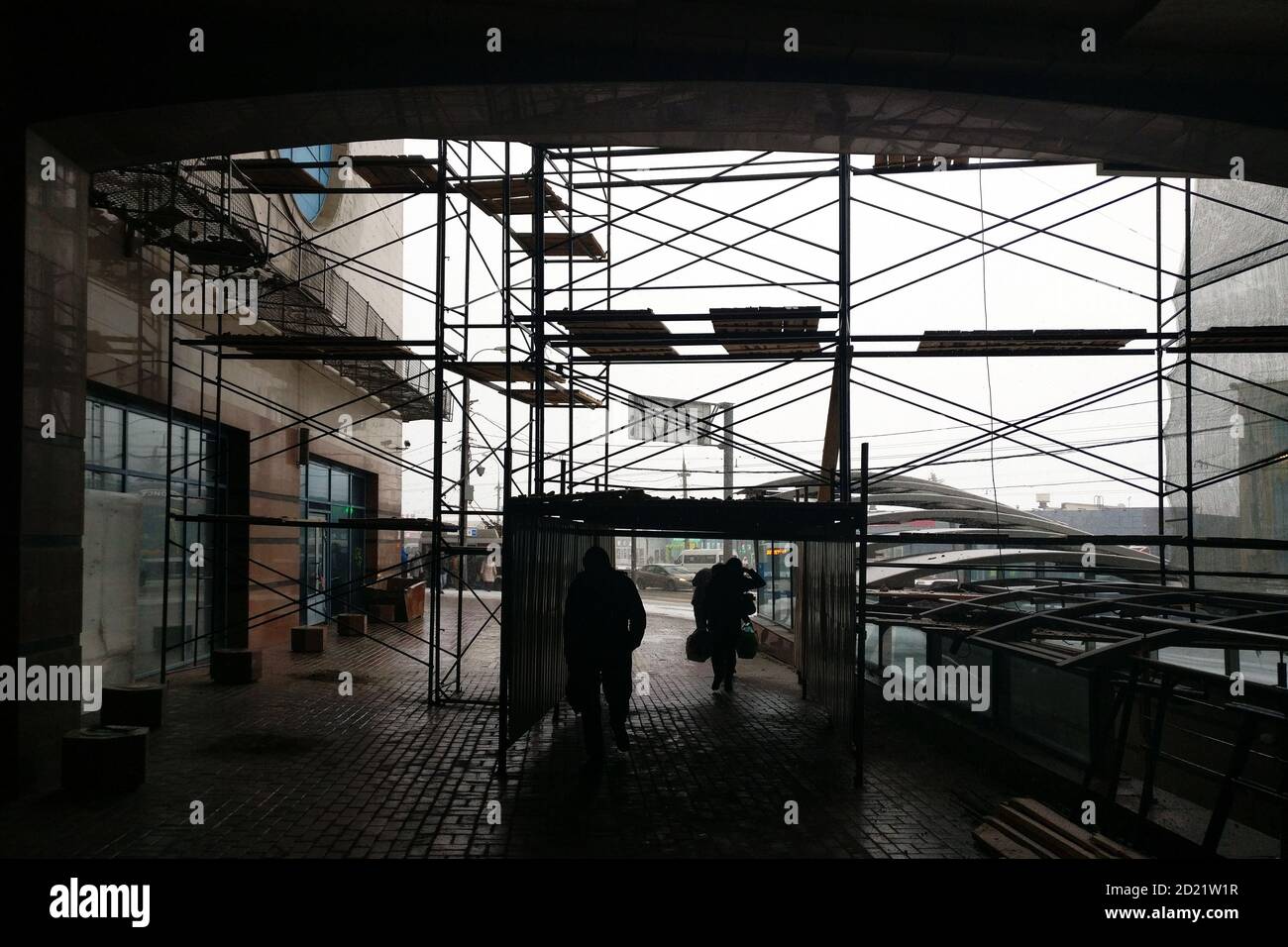 Scaffolding with arch for people. Silhouettes of people on the ...