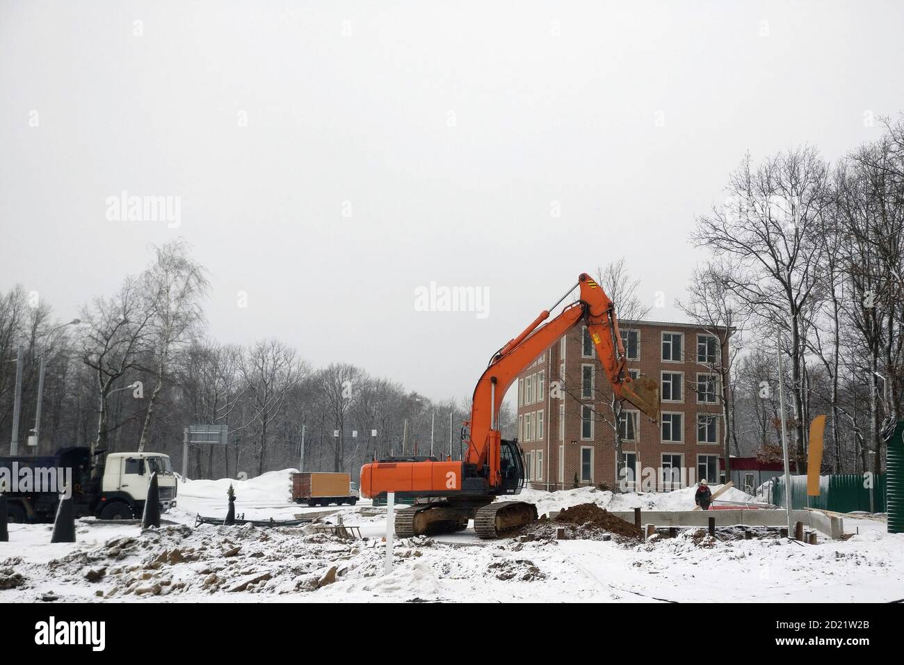 Construction equipment in winter. Truck and excavator in the snow when ...