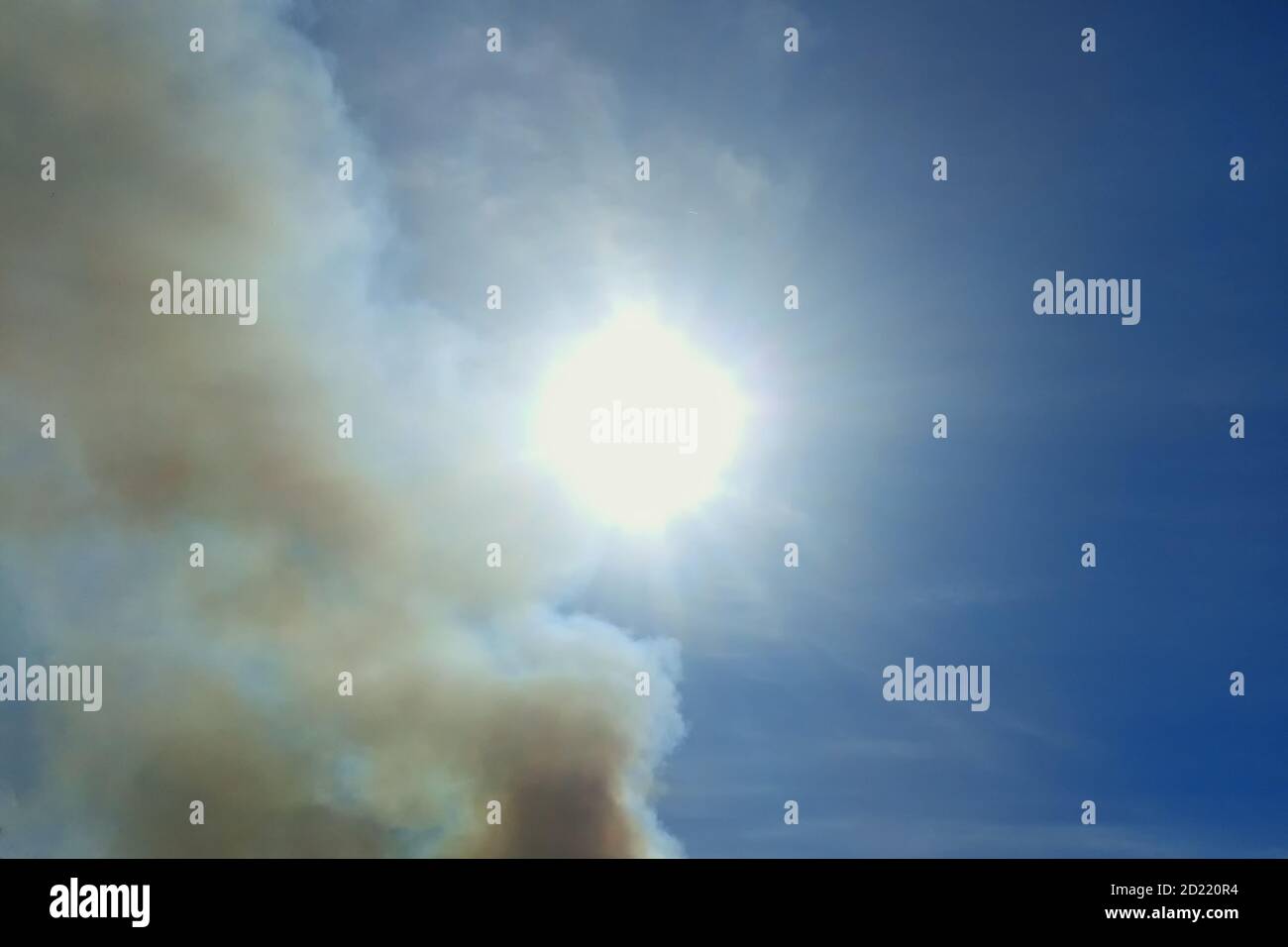 Smoke against sun. Smog and Sunny sky. Emissions of pollution into ...