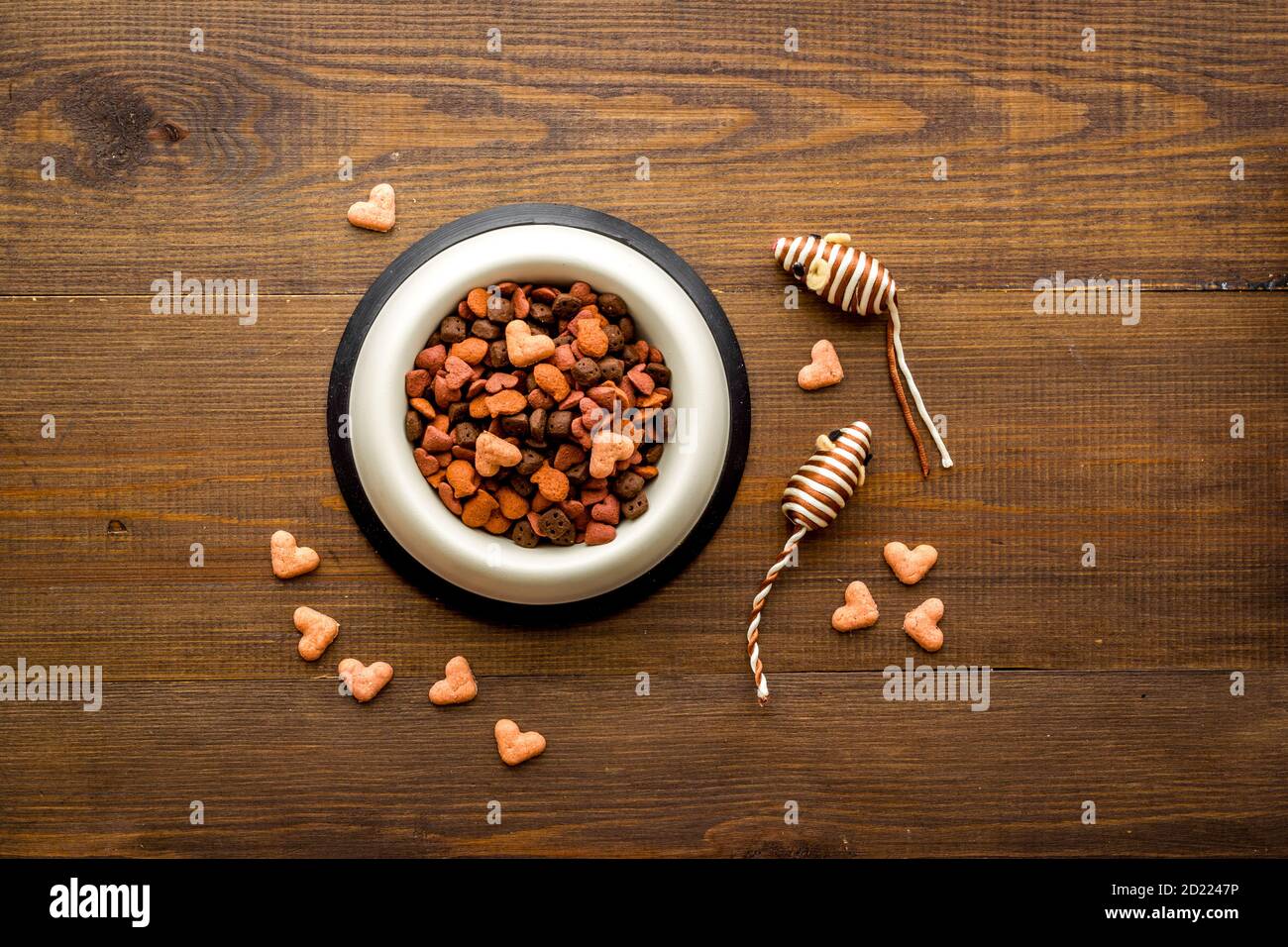 Dry cat food in bowl with toy, top view Stock Photo - Alamy