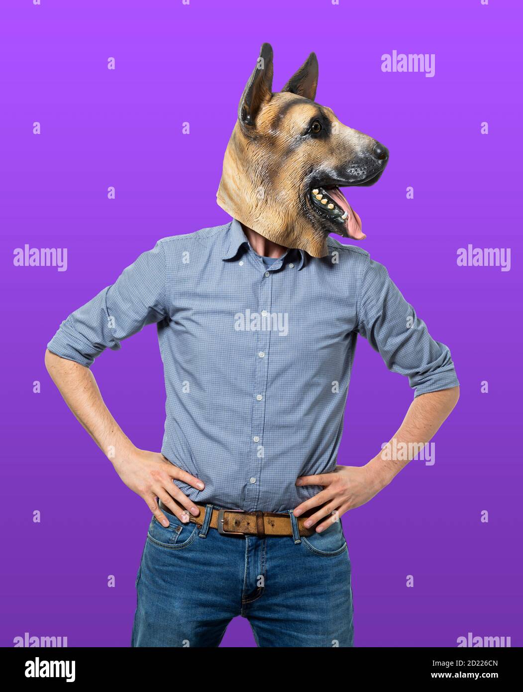 Man wearing dog mask with hands on hips and head turned looking away ...