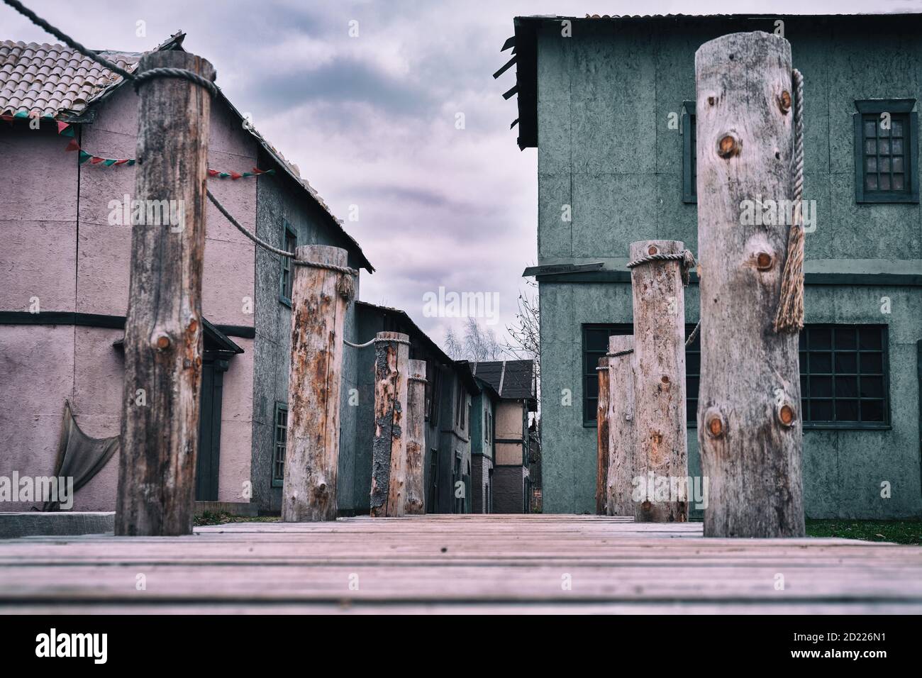 Old wooden bridge with rope railing in retro American city. A street of ...