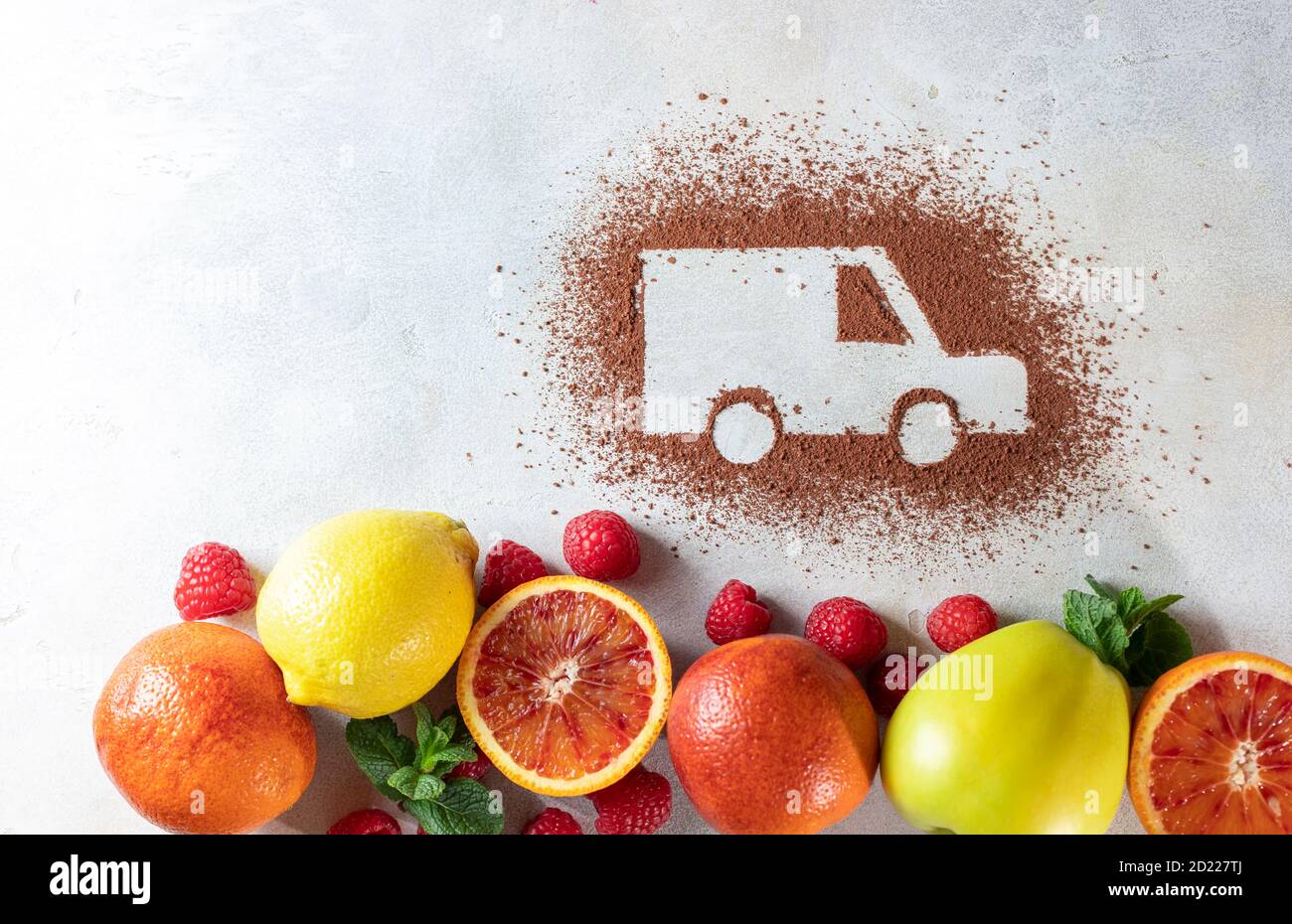 Car made of cocoa powder and citrus fruits on a light background ...