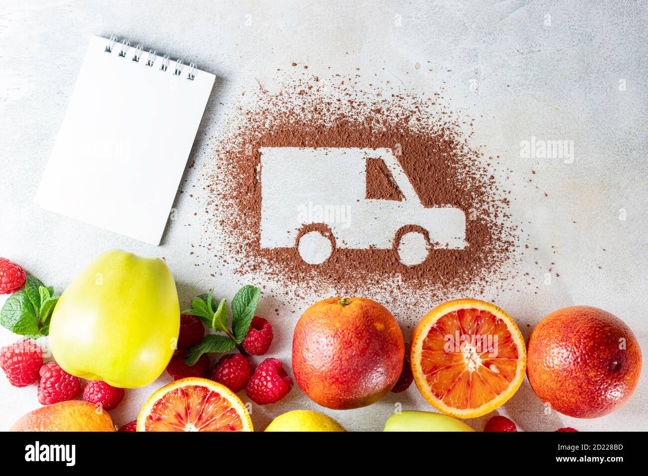 Car made of cocoa powder and citrus fruits on a light background ...
