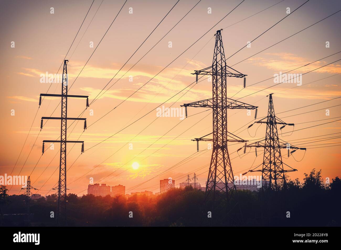 Power lines on the background of the city in the light of sunset Stock ...