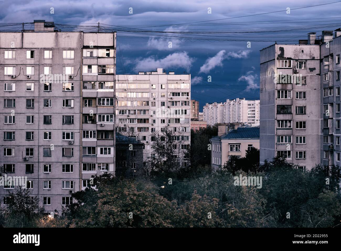 City gloomy high-rise buildings on a background of cloudy sky. Evening ...