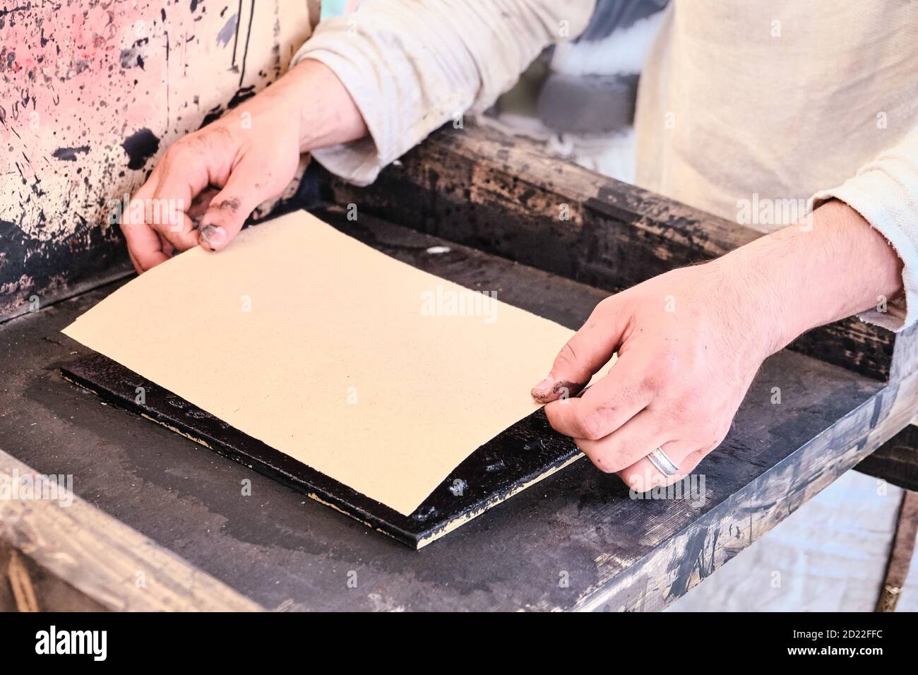 Hands men set the sheet on a retro printing book. Vintage typographic ...