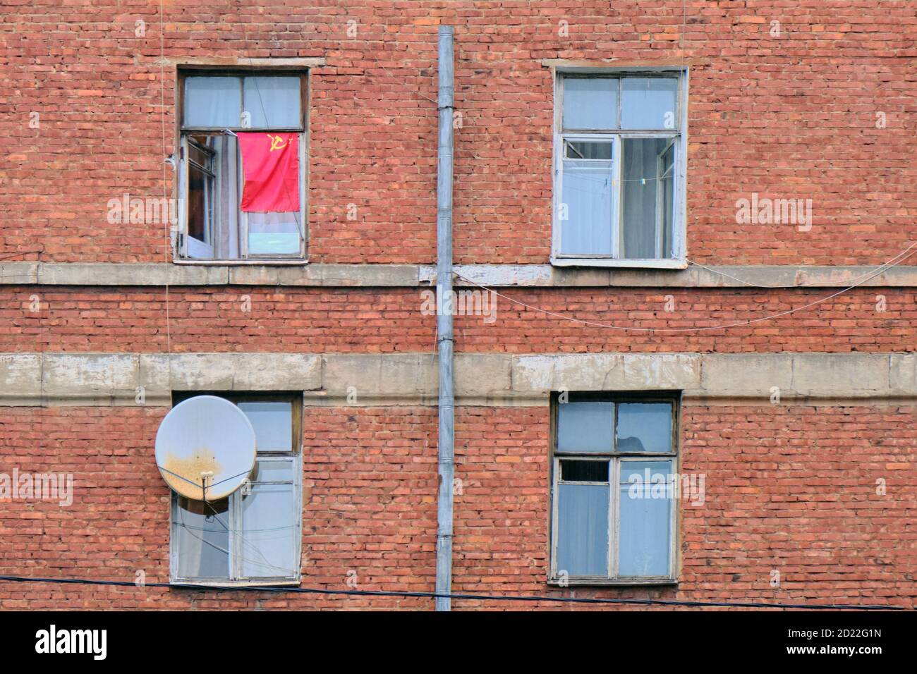 The Soviet flag is hung on an old red brick building USSR Stock Photo ...