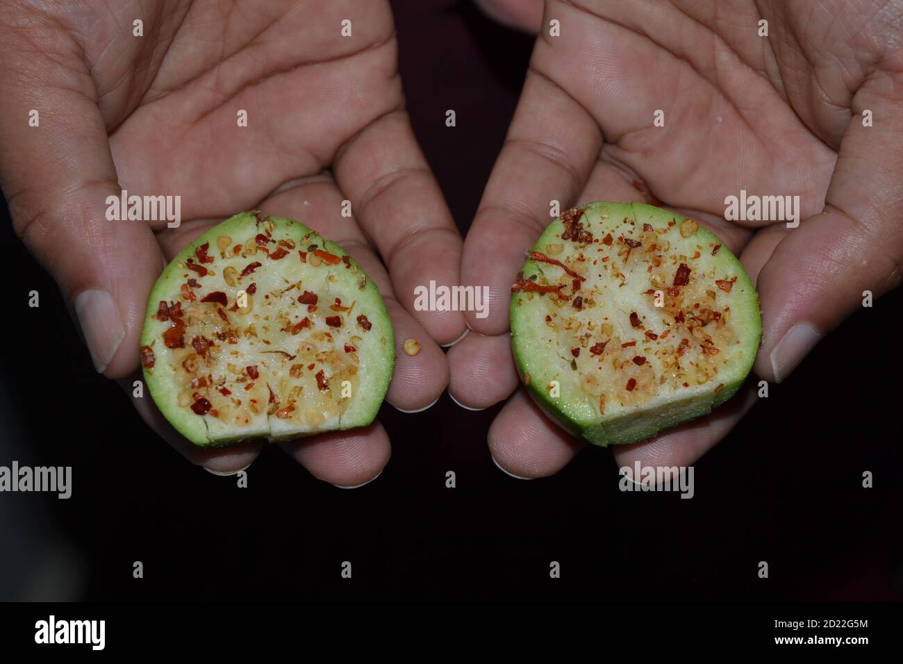 Guava fruits in two hands hi-res stock photography and images - Alamy