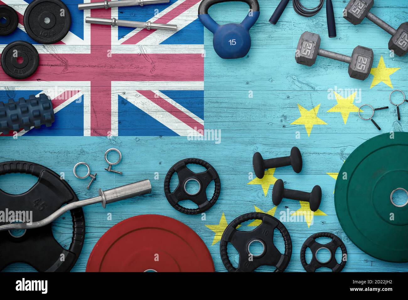 Tuvalu sports and fitness concept. Top view of heavy weight plates with ...