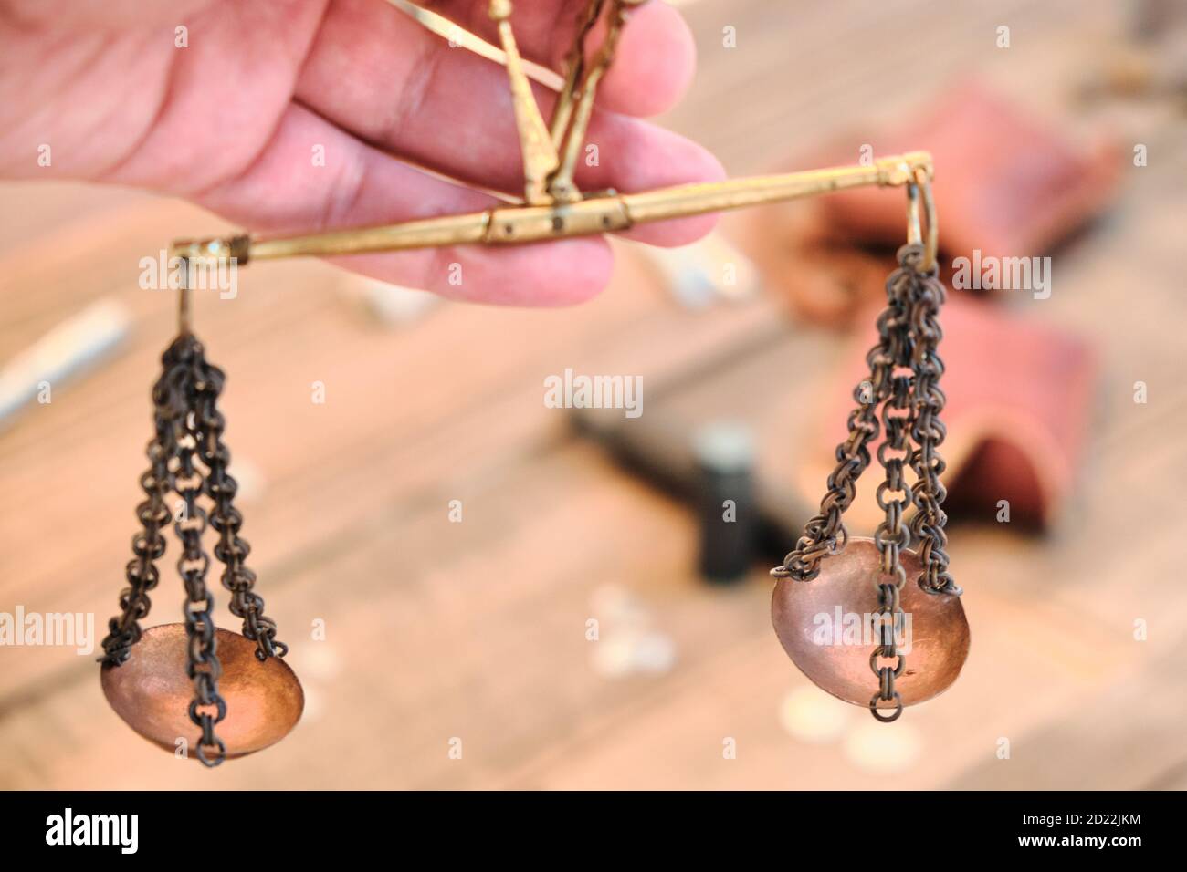 Scales of bronze on a chain in a woman's hand. Vintage scales for ...