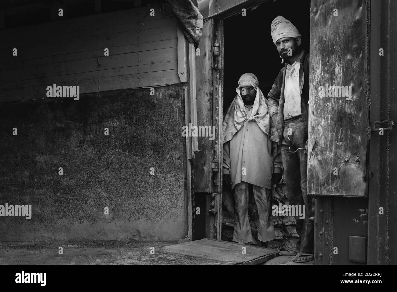 Portrait of men wearing only head scarf as protection employed to move ...