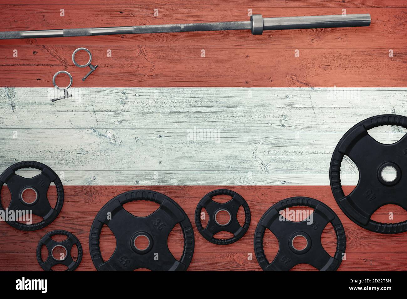 Austria gym concept. Top view of heavy weight plates with iron bar on ...