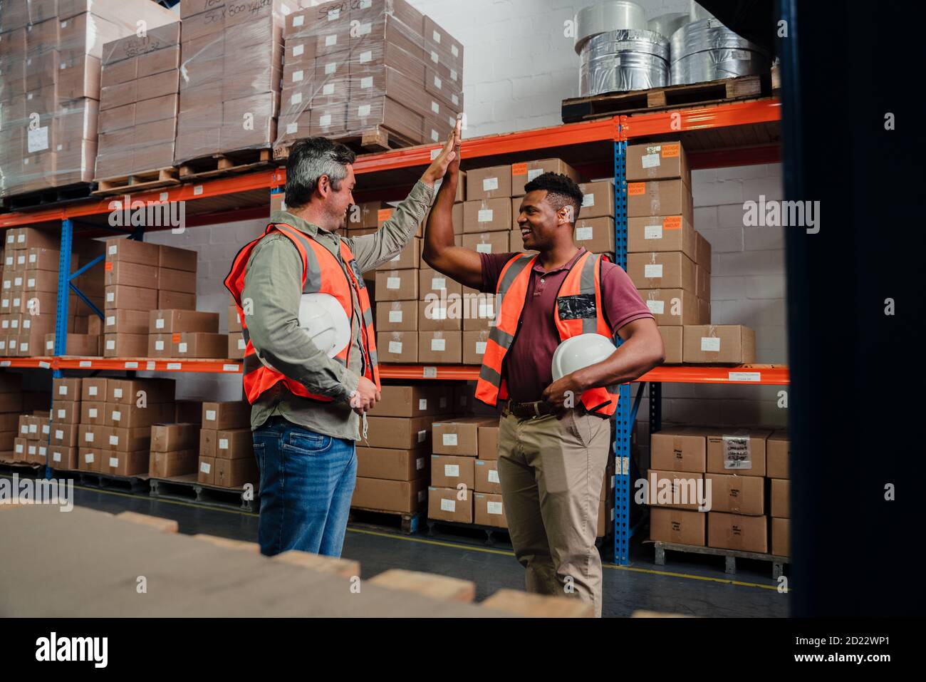 Male workers high five in congratulations of new business promotion ...