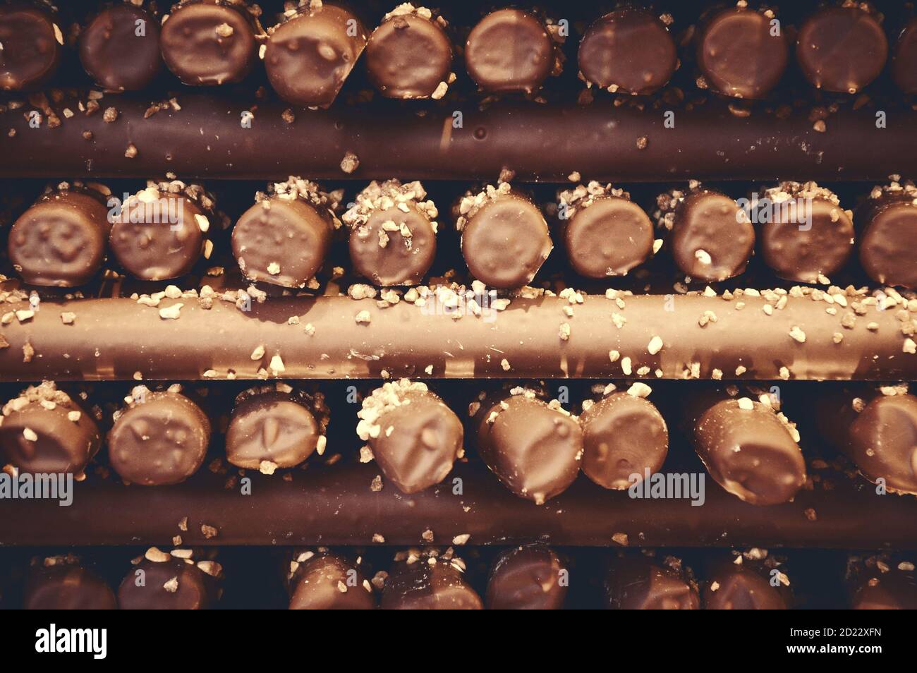 Dark chocolate sticks covered with nuts Stock Photo - Alamy