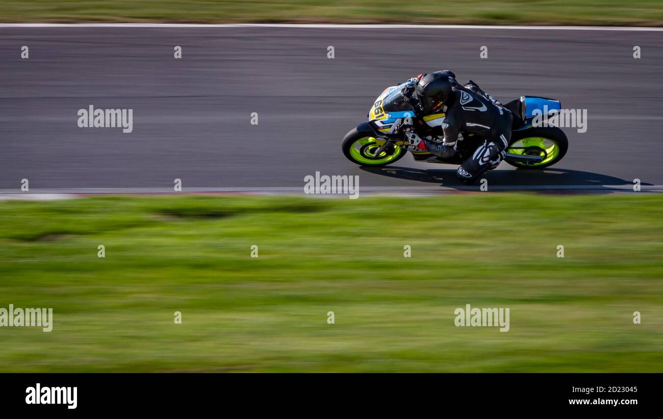 A panning shot of a racing bike cornering on a track Stock Photo - Alamy