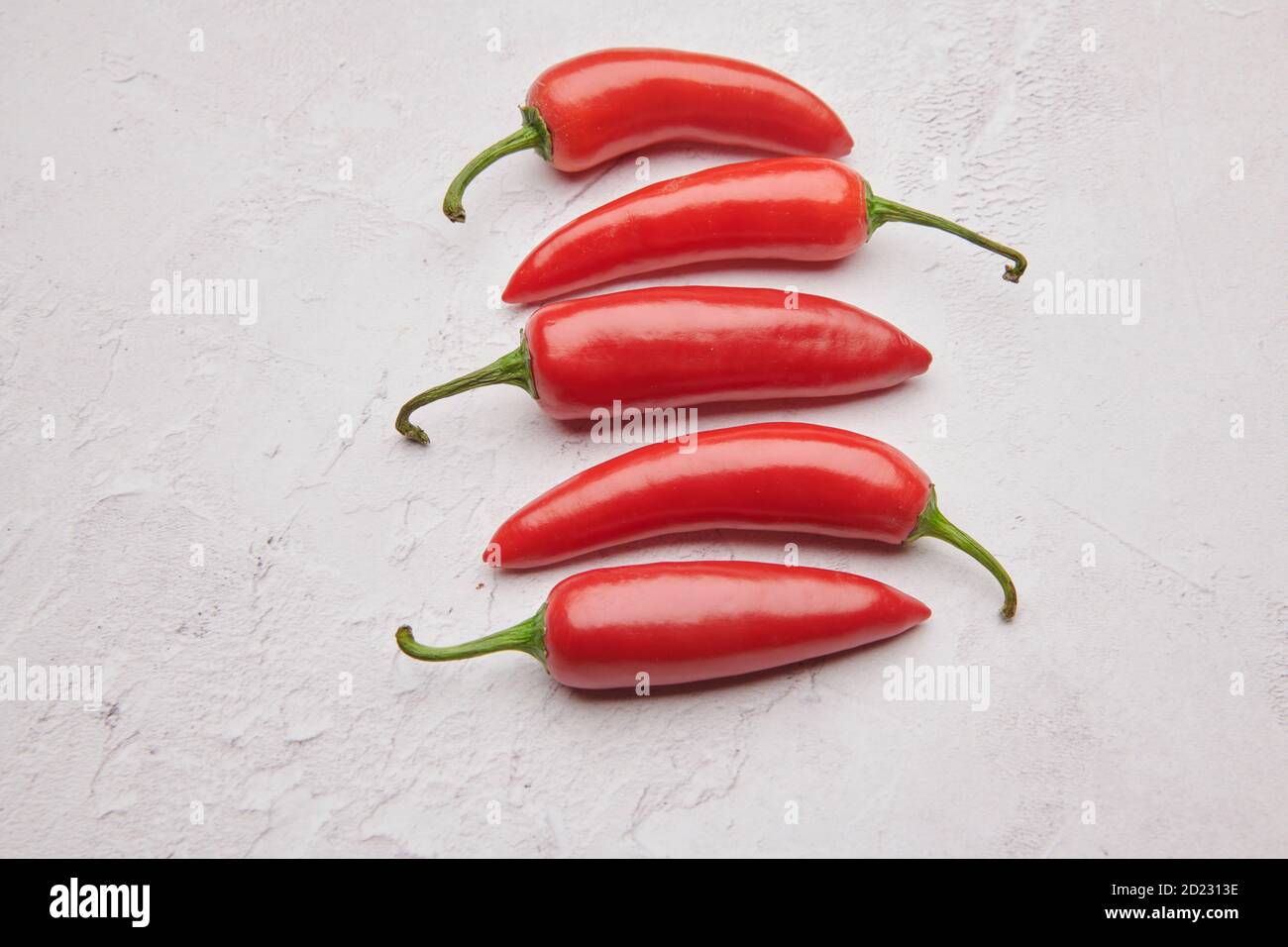 Chilli peppers on a white marble background, not cut out Stock Photo ...
