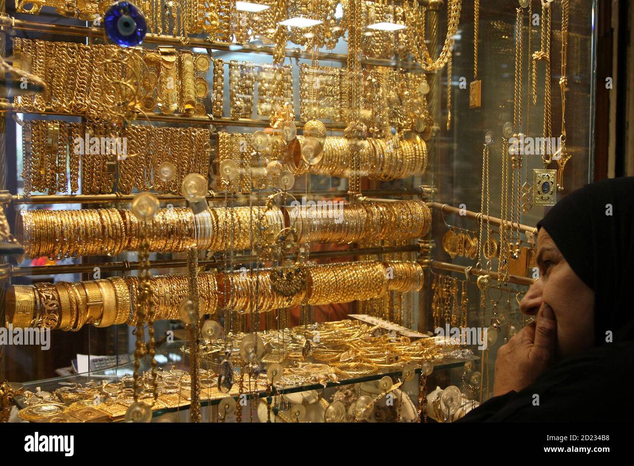 Woman looks at gold hi-res stock photography and images - Alamy