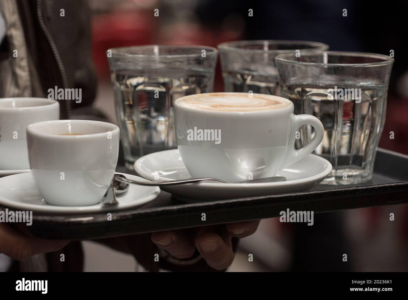 ordering and drinking a cup of coffee in a coffee house Stock Photo - Alamy