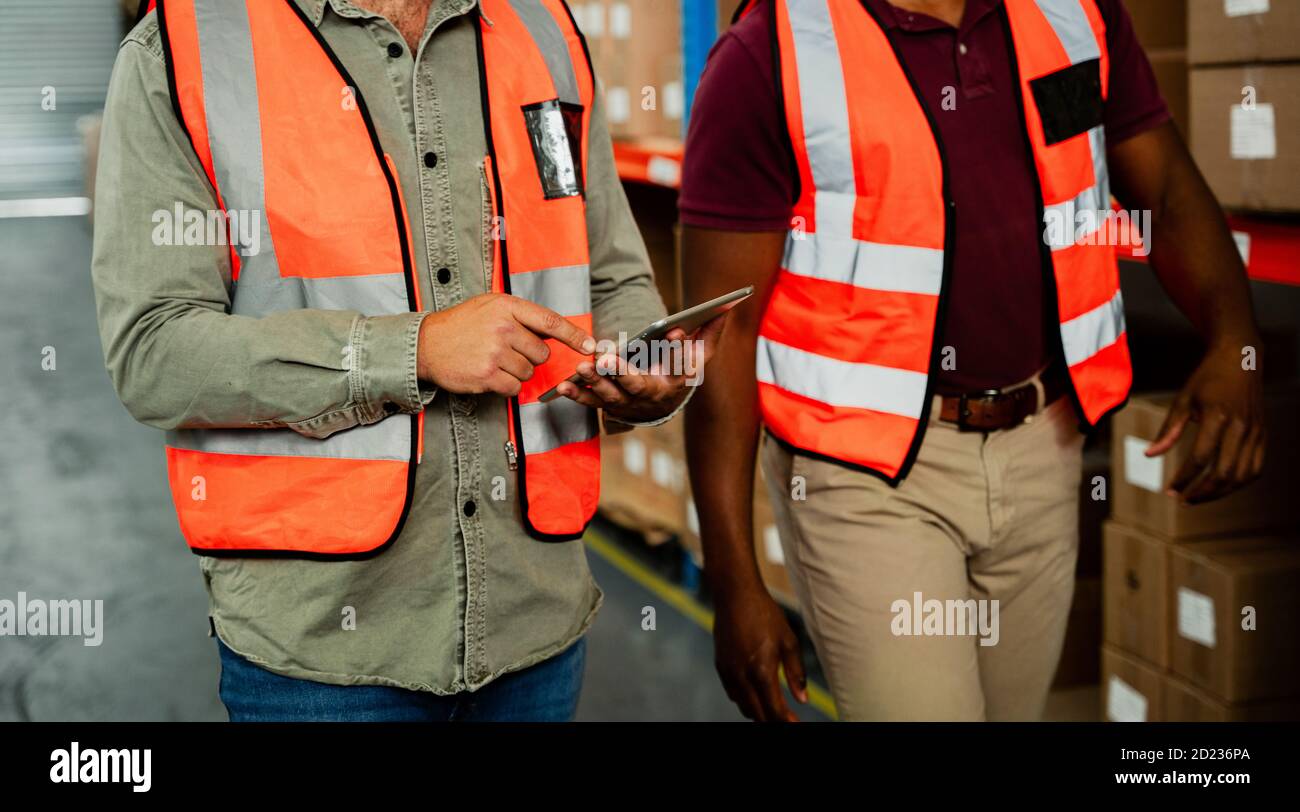 Two male colleagues tapping tablet hi-res stock photography and images ...