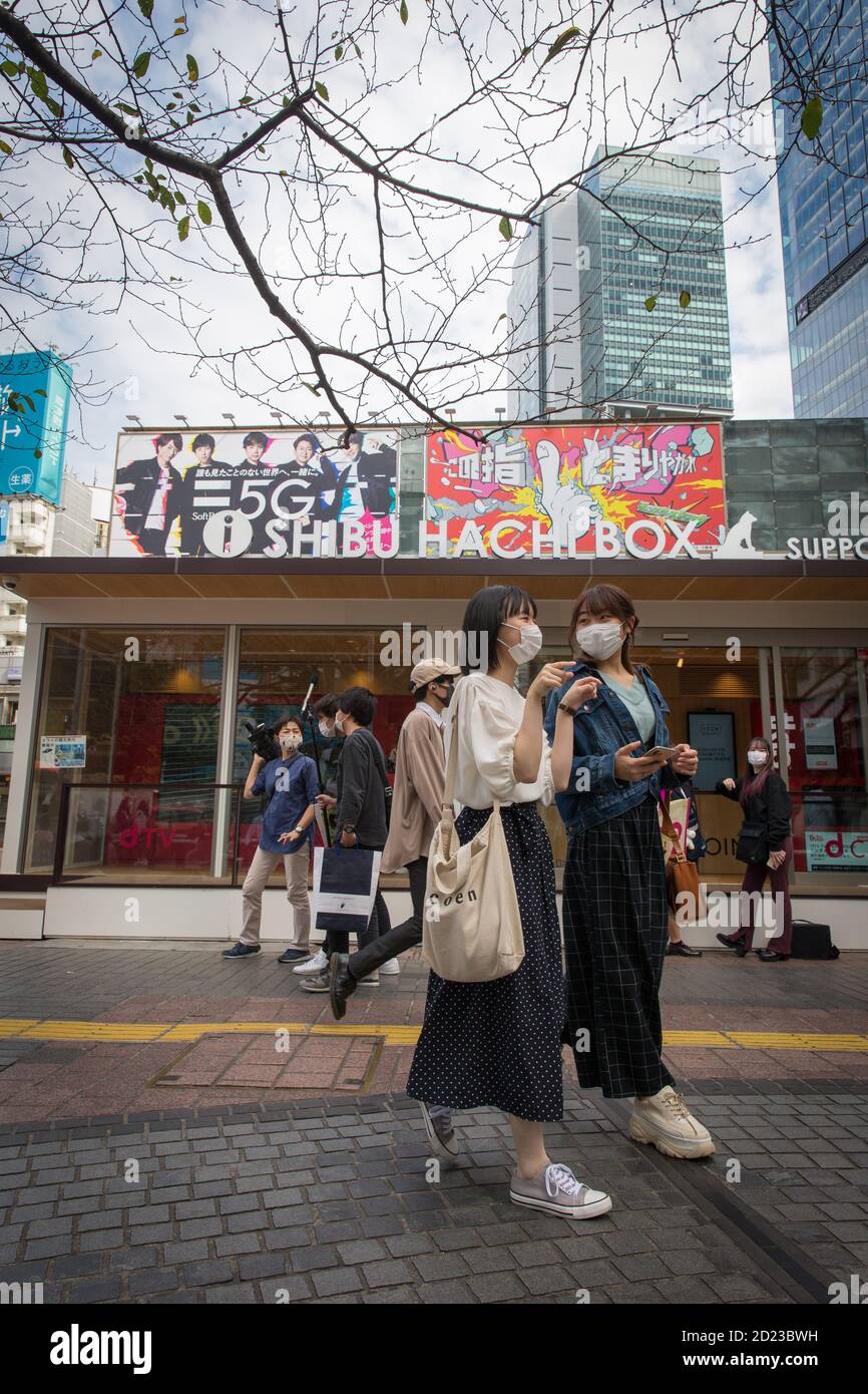 Tokyo, Japan. 06th Oct, 2020. People wearing face masks walk past a newly opened tourist ...