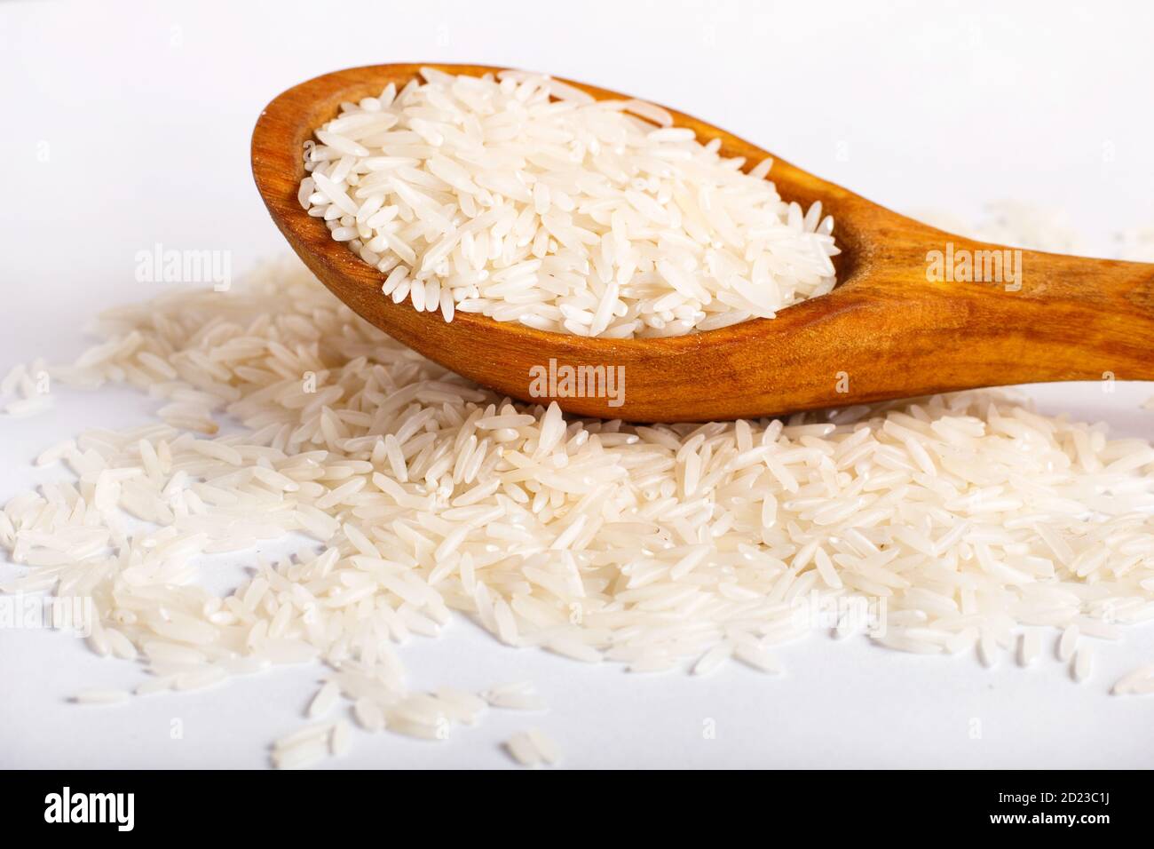 Pile of basmati rice in a wooden spoon isolated on white background ...